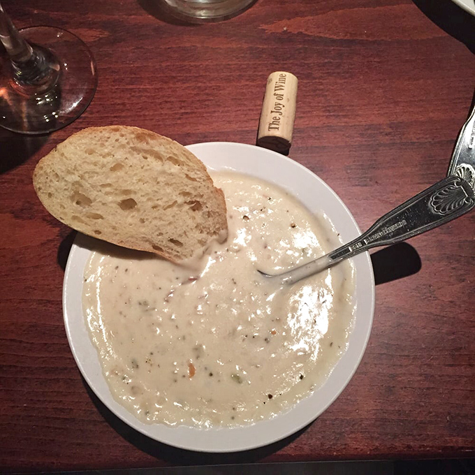 The holy grail of chowders arrives with appropriate ceremony—creamy, not gloppy, with tender clams that remind you this isn't potato soup with occasional seafood cameos.