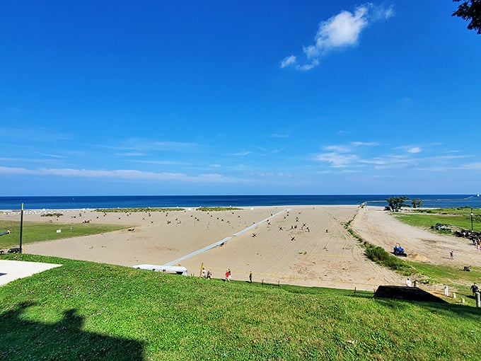 Lake Erie stretches to the horizon at Conneaut Township Park, where golden sands invite barefoot wandering and sunset-watching.