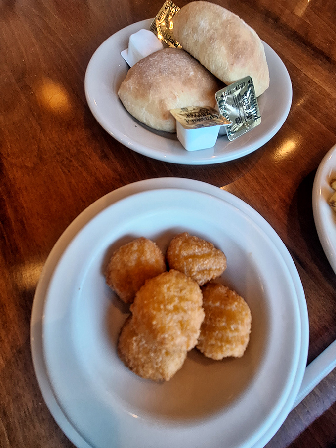 Golden corn nuggets arrive like little treasures – crispy outside, sweet and tender inside – paired with fresh-baked rolls that demand butter's attention.