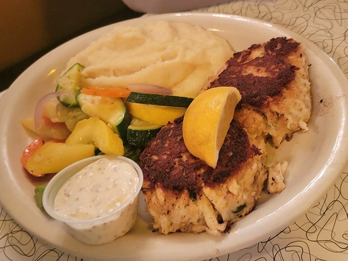 Golden-brown crab cakes that look like they've achieved the perfect ratio of crab to binding—the culinary equivalent of finding a parking spot right in front of your destination. 