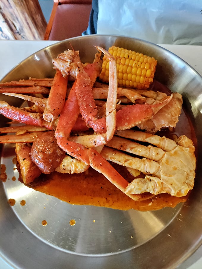 Crab legs sprawled majestically in spicy sauce—nature's perfect design for both maximum flavor extraction and the joy of working for your food.
