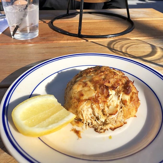 The legendary crab cake in all its golden-crusted glory. Notice how it's barely holding together—that's pure crab meat, folks, not filler.