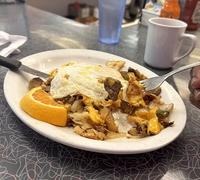 Breakfast alchemy at its finest—a skillet where eggs, cheese, and potatoes unite in a harmony that Mozart would envy.