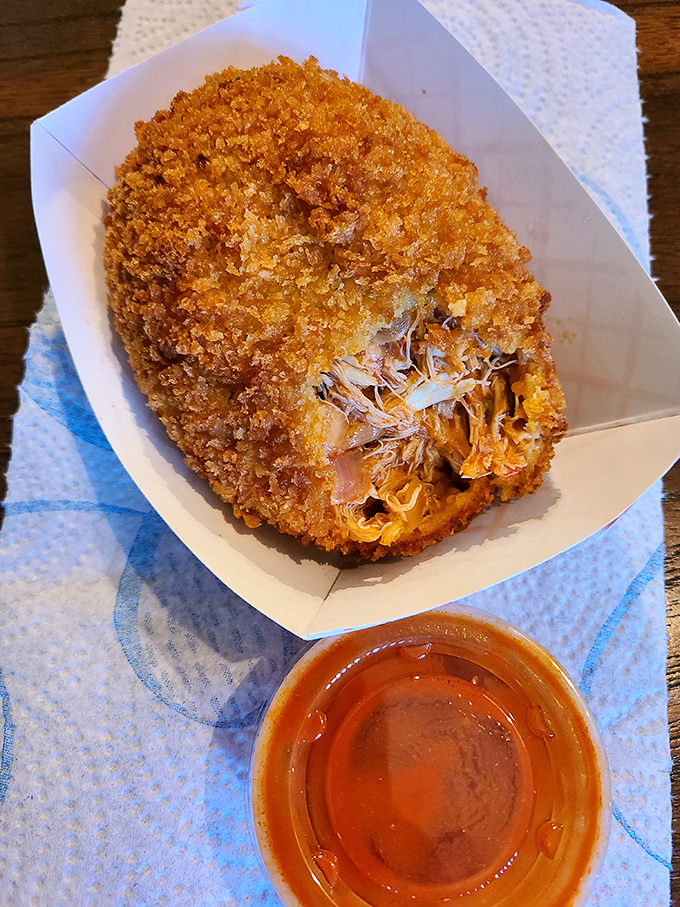 The deviled crab: a golden-fried treasure chest of seasoned crabmeat that crunches like nature's perfect potato chip before revealing its savory secrets.