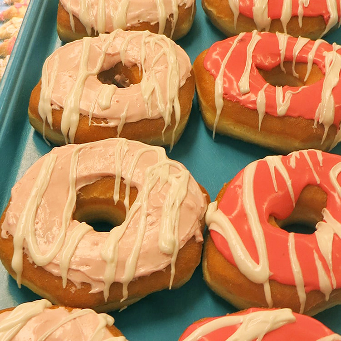 Pink and coral donuts drizzled with white icing—proof that sometimes the most beautiful things in life are also the most delicious.