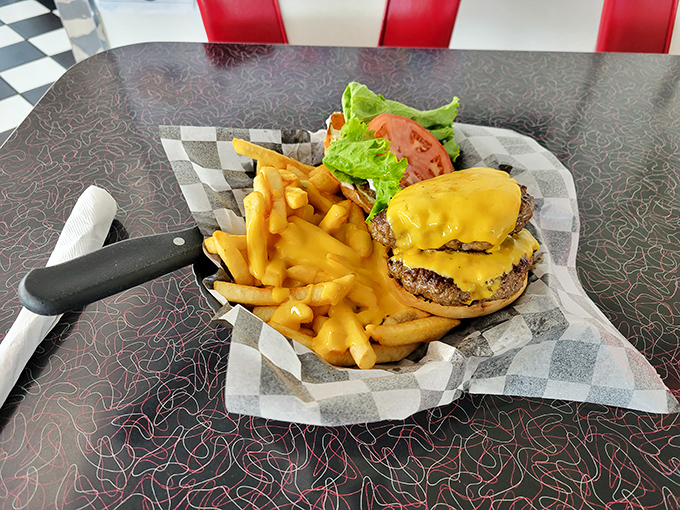 This isn't just a cheeseburger—it's America between two buns. Golden fries standing at attention, ready for their delicious duty.