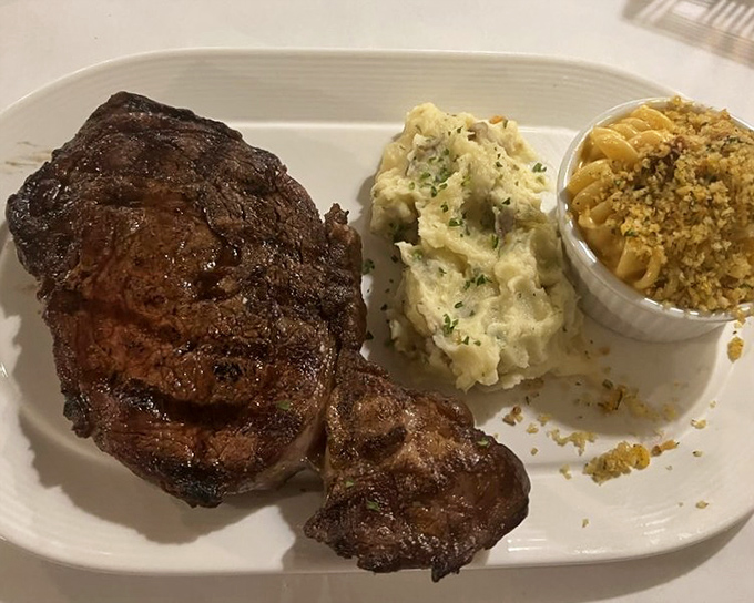 Behold the star of the show – a perfectly charred ribeye with sides that know their supporting role. This isn't dinner; it's a religious experience.