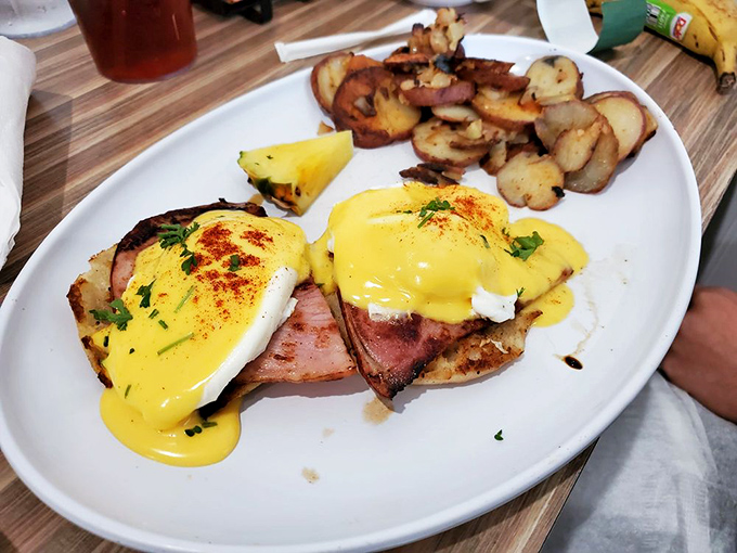 Behold, the star of the show! Golden hollandaise cascades over perfectly poached eggs and Canadian bacon – breakfast nirvana on a plate.