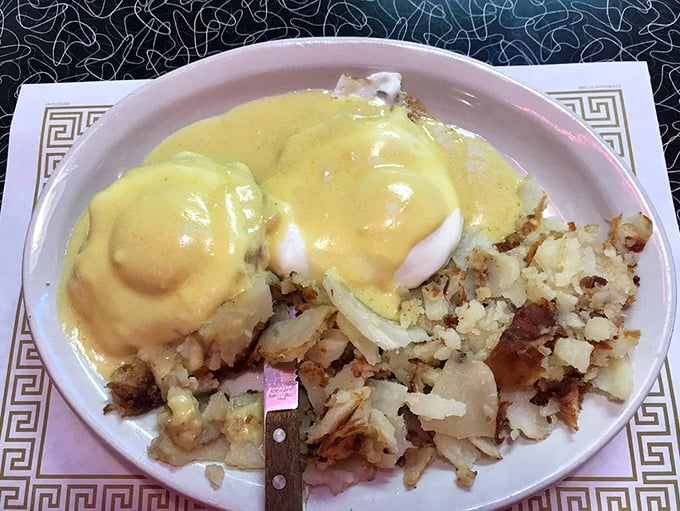 Hollandaise cascading over perfectly poached eggs like a sunrise over Columbus – Tommy's Eggs Benedict is breakfast architecture at its finest.