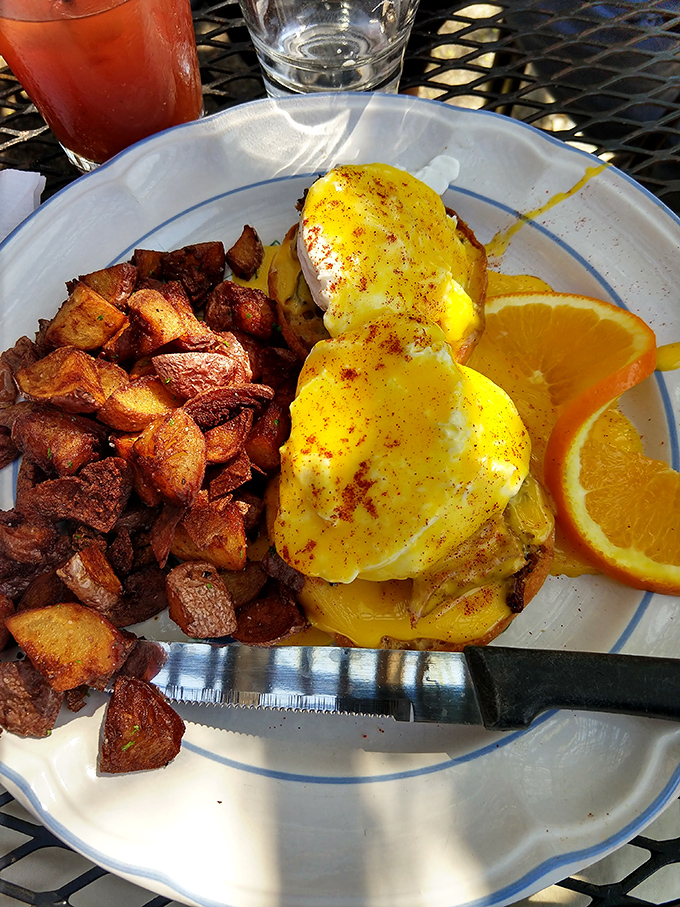 Eggs Benedict reimagined with a Midwestern generosity – those potatoes aren't just a side, they're practically their own main event.