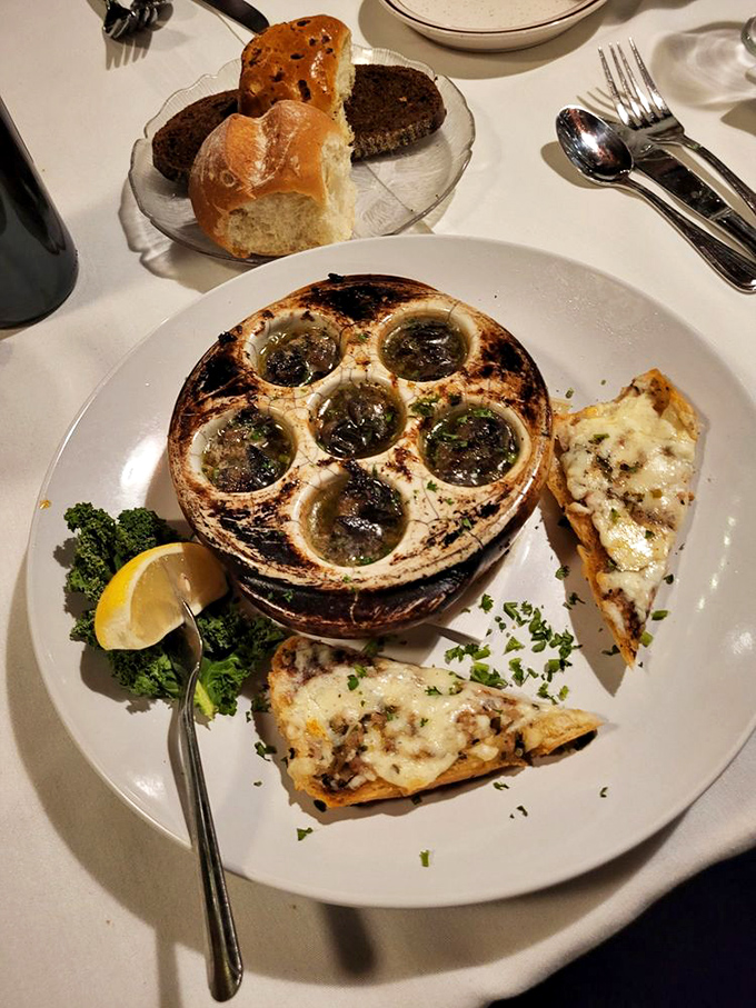 Escargot that would make Julia Child swoon—buttery, garlicky perfection nestled in their ceramic cradle, with crusty bread for essential sauce-sopping.