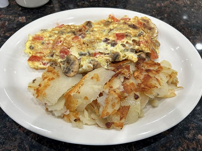 Behold the Farmer's Omelet in its golden glory! Those crispy home fries aren't just a side dish – they're the supporting actors deserving their own Oscar.