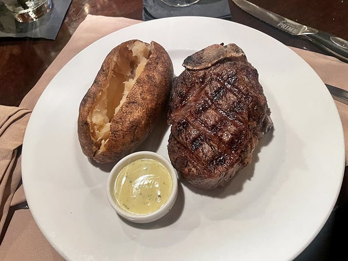 A perfectly cooked filet mignon alongside a baked potato—proof that sometimes the simplest combinations create the most profound happiness.