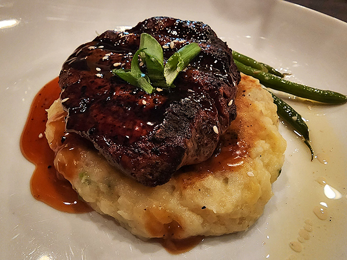 Behold the star of our show: a perfectly seared filet mignon atop creamy mashed potatoes. This isn't dinner; it's a religious experience.