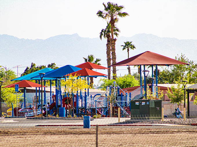 Colorful playground equipment pops against the mountain backdrop, a welcome oasis for families seeking shade and fun in equal measure.