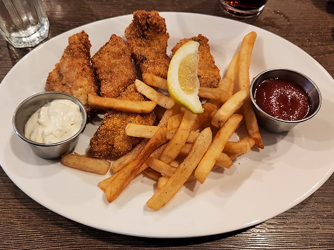 The legendary fish and chips – golden, crispy perfection that makes you wonder if you've ever truly had fish and chips before this moment.