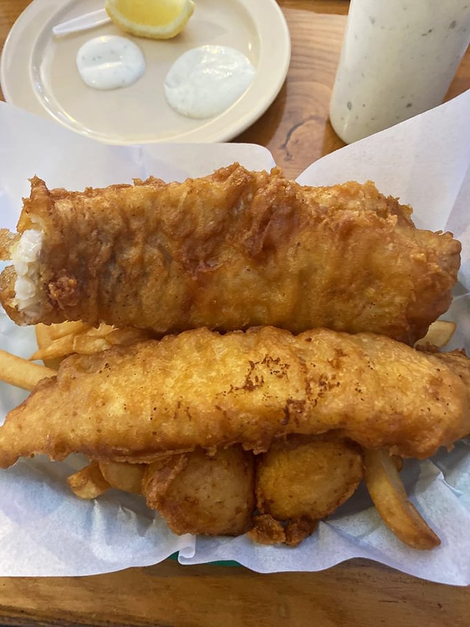 Golden-battered fish that shatters with each bite, revealing pearly white flesh within. The kind of meal that makes you forget your table manners.
