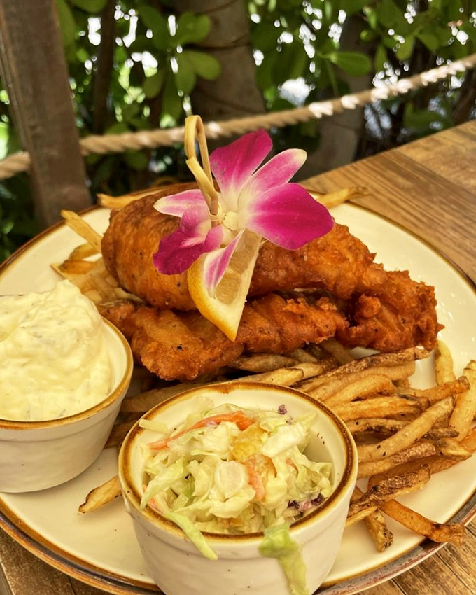 That orchid garnish isn't compensating for anything—this fish is so fresh it might still have its sea legs. Crispy perfection.