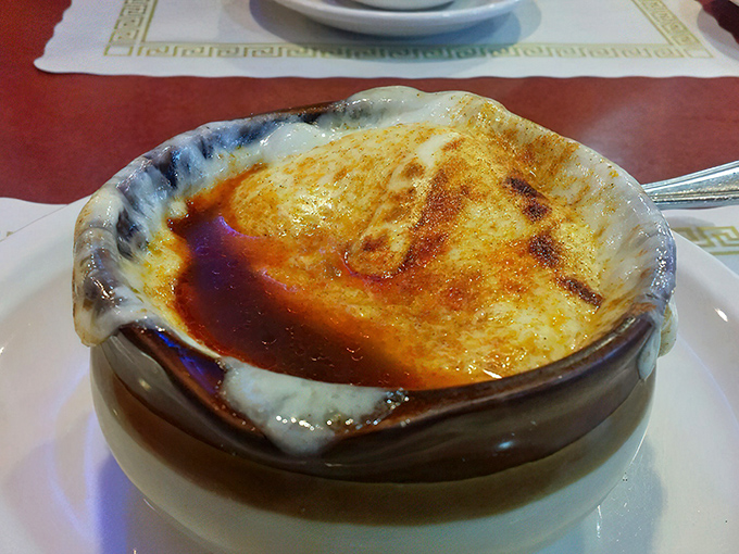 This isn't just French onion soup—it's a cheese-crowned cathedral of flavor that's worth every moment spent untangling strings of molten provolone.
