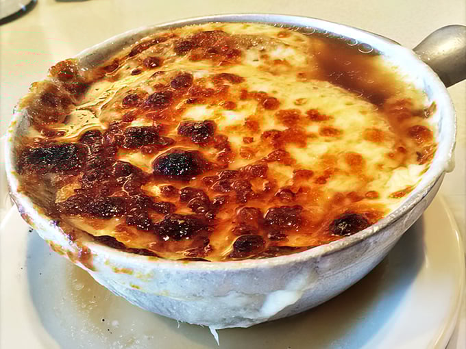 Behold the French onion soup in all its glory—that cheese cap browned to bubbling perfection is like a savory crème brûlée for grown-ups.