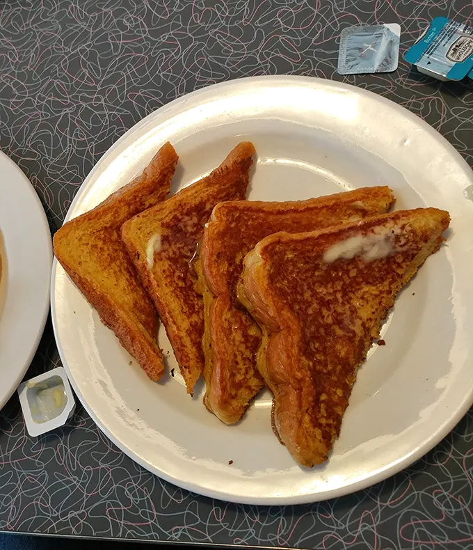 Golden-brown French toast that's achieved that mythical balance: crispy edges with a custardy center that makes you forget about adulting.