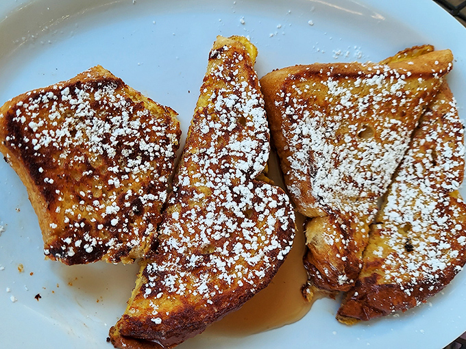 Golden, crispy exterior. Custardy, pillowy interior. This French toast doesn't just set the bar—it is the bar. That dusting of powdered sugar? Chef's kiss.