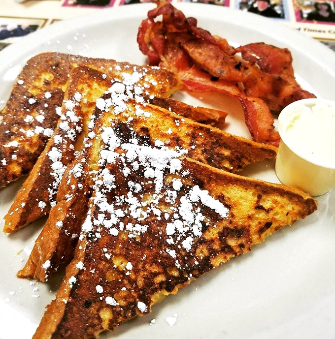 Golden-brown perfection dusted with powdered sugar. This French toast achieves that mythical balance—crispy edges surrendering to a custardy center that makes morning people of us all.