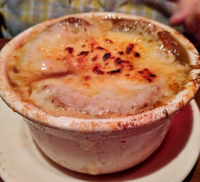 Behold the legendary French onion soup – a bubbling cauldron of perfectly browned cheese concealing a savory broth that's worth every stretchy, gooey bite.