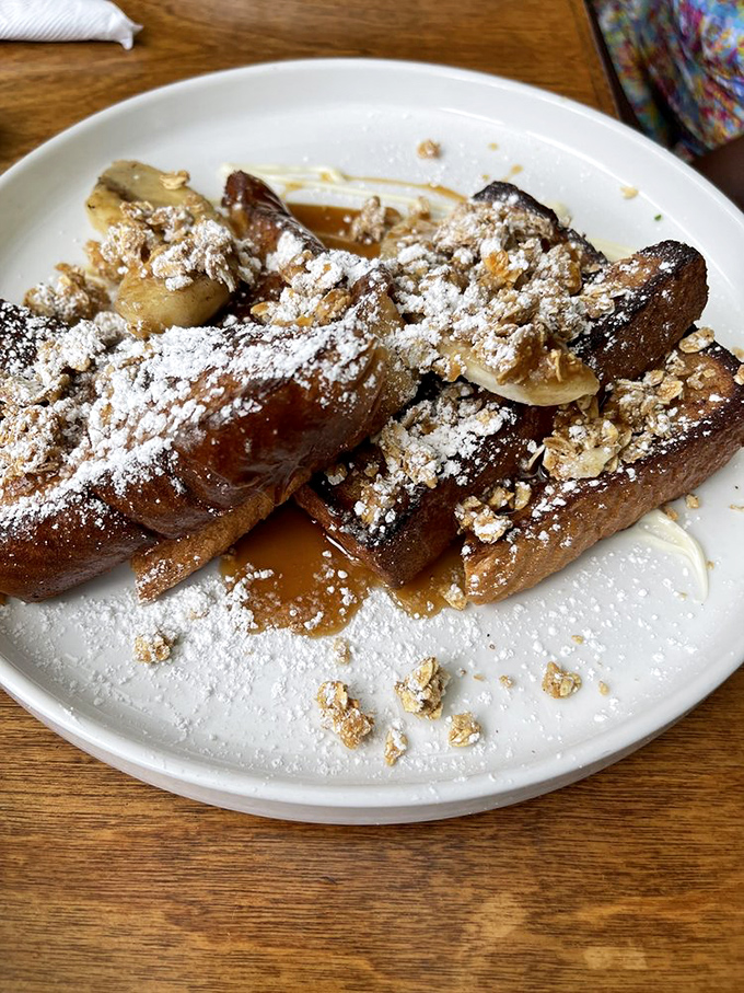 French toast that's dressed for the red carpet—caramelized bananas, powdered sugar, and granola create a breakfast that's thinking seriously about running for dessert.