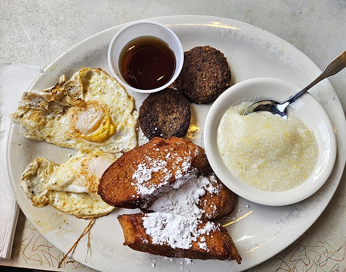 Breakfast alchemy: eggs sunny-side up, powdered sugar-dusted French toast, and grits that would make your grandmother nod in approval