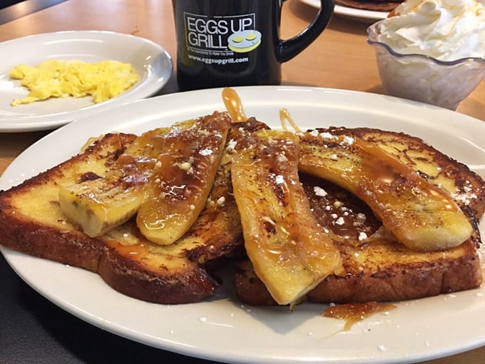French toast elevated to an art form, topped with caramelized bananas and drizzled with syrup. This isn't breakfast—it's morning dessert disguised as nutrition.