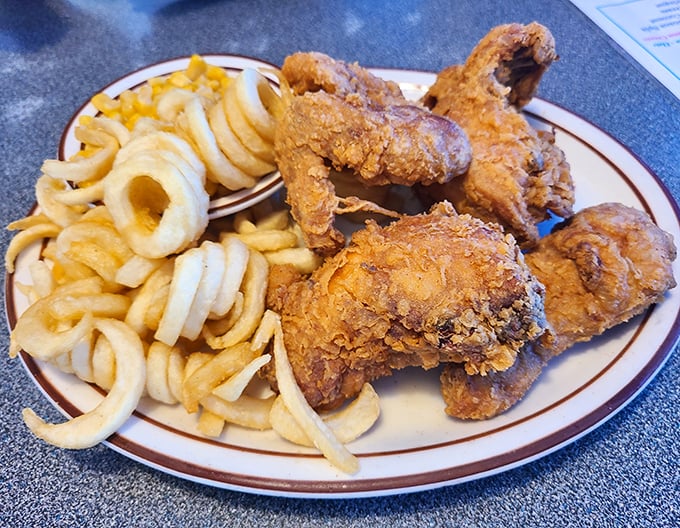 Golden-fried chicken that makes a sound so satisfying when you bite into it, nearby diners will experience serious food envy. Those onion rings aren't just sides—they're halos.