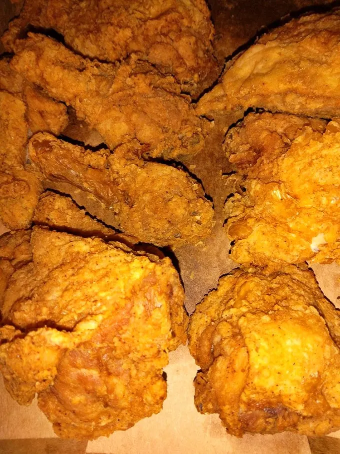 Golden-brown fried chicken that crackles with each bite – the kind that makes you wonder if your grandmother secretly moonlights in the kitchen.
