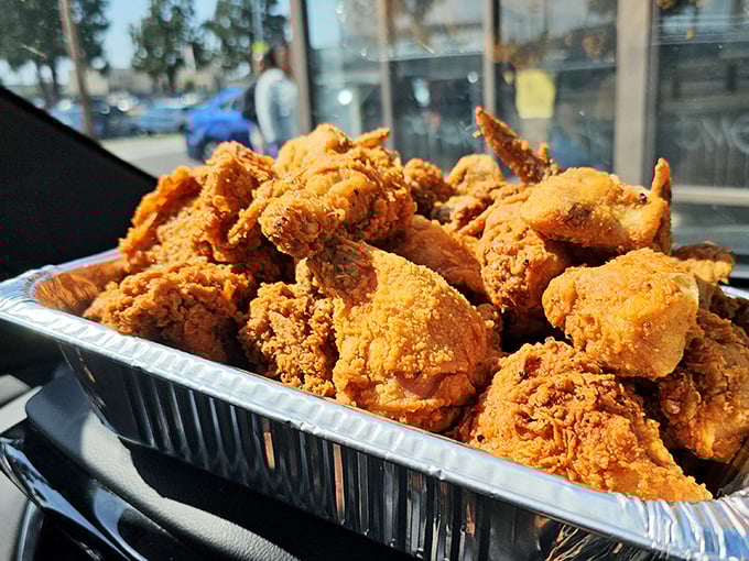 Golden-brown perfection in aluminum form. This isn't Instagram bait; it's the real deal—chicken that makes you forget your table manners and reach for another piece.