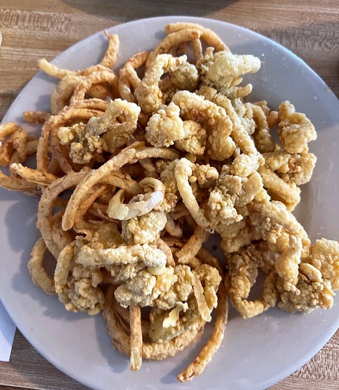 Golden treasures from the deep! These fried clams aren't just food—they're little crispy love letters from the ocean.