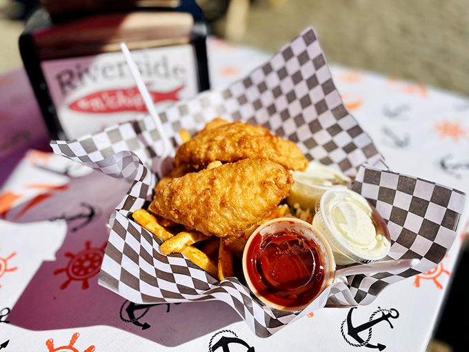 Golden-battered cod that shatters with each bite, served unpretentiously in checkered paper—proof that perfection needs no fancy presentation.