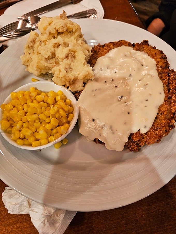 Behold, the holy trinity of comfort food: golden-crusted chicken fried steak, cloud-like mashed potatoes, and sweet corn. Grandma would approve, then steal your plate.