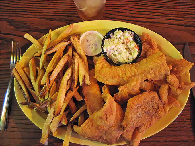 Golden-fried walleye that shatters with each bite, paired with hand-cut fries that could make a potato farmer weep with pride.