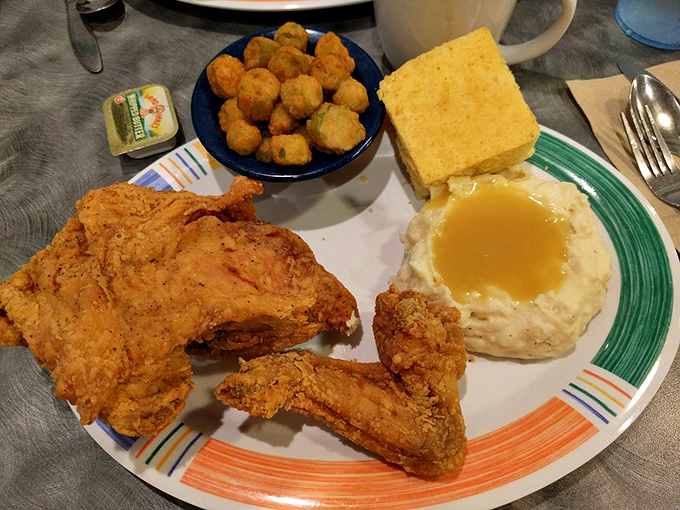Golden-brown chicken that makes that perfect crunch sound—nature's dinner bell. Those okra nuggets and cornbread aren't just sides; they're supporting characters in a comfort food blockbuster.