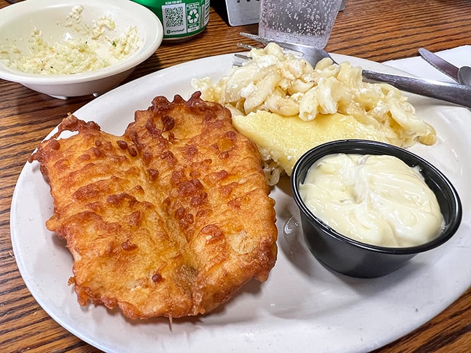 Golden-battered fish that shatters with each bite, paired with creamy mac and cheese that would make any childhood memory jealous.