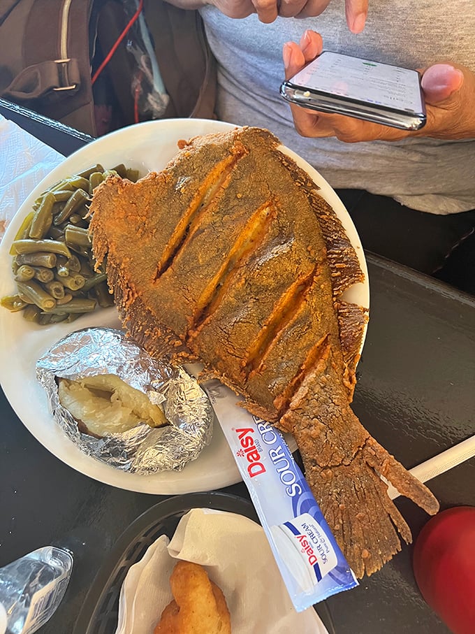 This fried flounder isn't messing around—it's the Moby Dick of fish plates, perfectly cornmeal-crusted and taking up real estate on the plate like it owns the place.