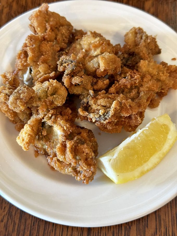 Golden-fried oysters that crackle with each bite, served with a lemon wedge that's not just garnish but an essential supporting actor.