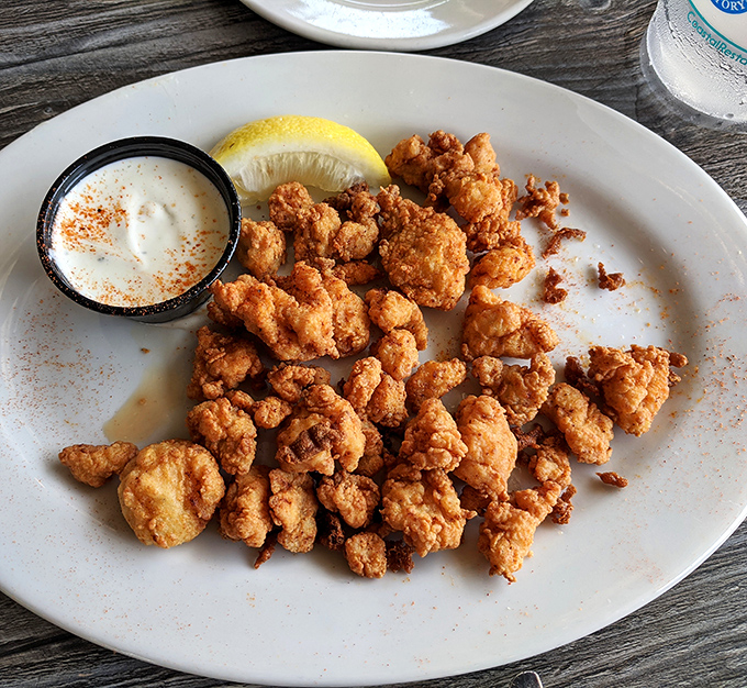 Golden-fried nuggets of happiness served with a side of zesty sauce—proof that sometimes the best things come in small, crunchy packages.