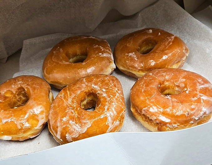 Golden halos of fried perfection. These glazed donuts aren't just breakfast – they're edible sunshine that makes Monday mornings bearable again.