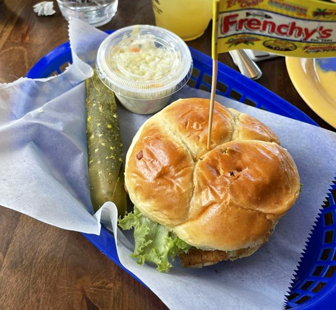 Behold the star of the show—a grouper sandwich so perfect it should have its own agent. That golden bun barely contains the glory within.