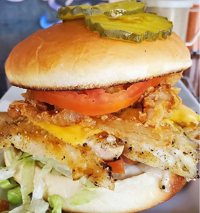 This grouper sandwich isn't just food—it's edible architecture, with layers of crispy fish, fresh veggies, and melty cheese creating the Taj Mahal of seafood sandwiches.