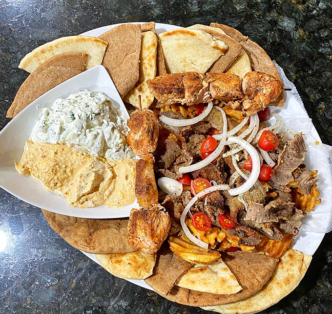 This isn't just a platter; it's a Mediterranean vacation for your mouth, complete with pillowy pita and tzatziki worthy of the gods.