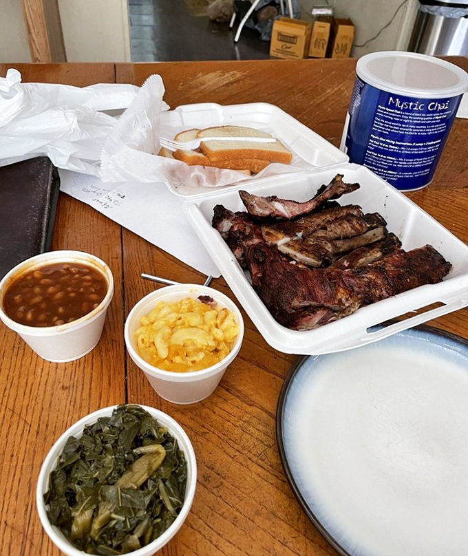 Meat and sides in perfect harmony—like a barbecue symphony where ribs are the conductor. Those collard greens deserve their own fan club. 