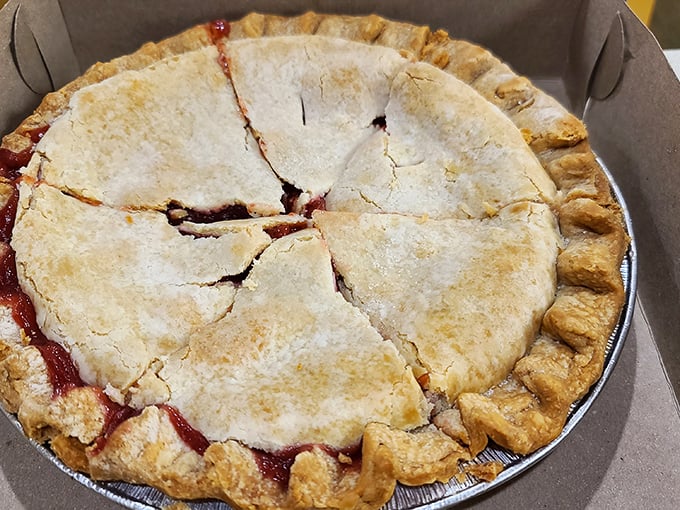 This isn't just pie—it's edible architecture with a perfectly crimped crust and ruby filling peeking through deliberate vents. Grandmothers everywhere would approve.