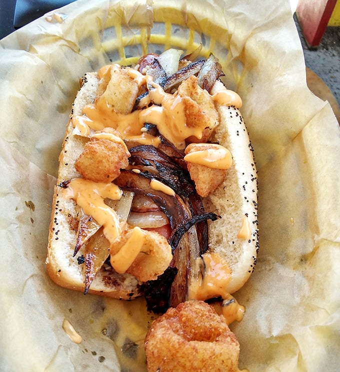This isn't just a hot dog – it's a masterpiece of textures and flavors, where crispy toppings and melty cheese create perfect harmony.